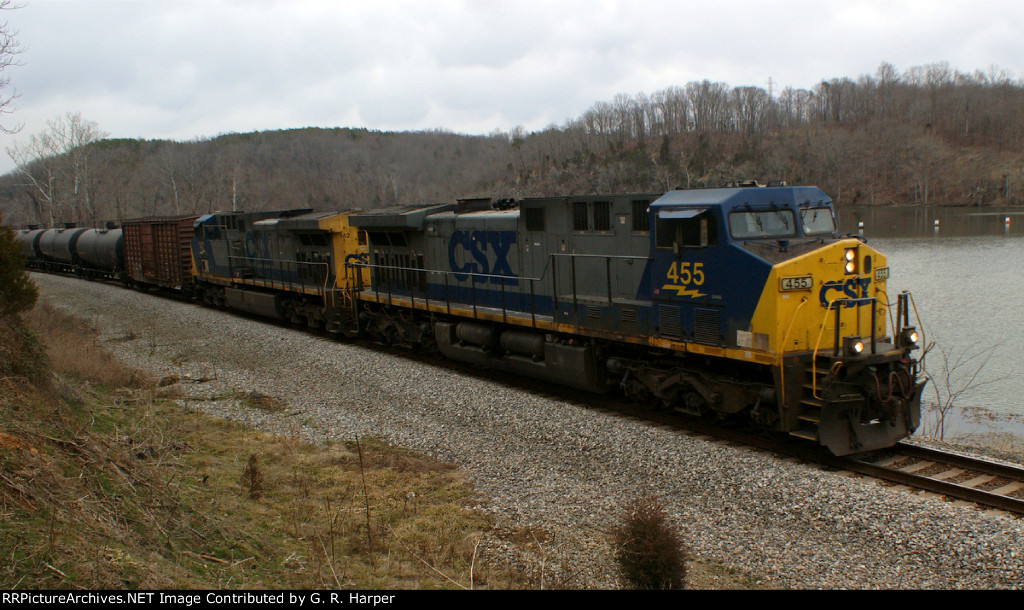 774 - CSXT 455 leads K08814 oil train EB along the Reusens Dam pond under a gloomy sky.